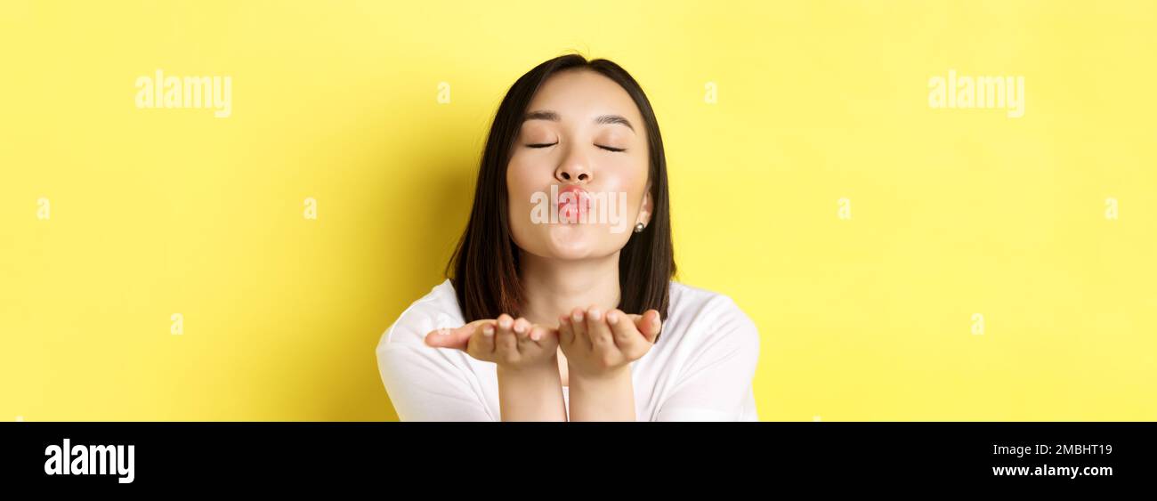 Valentines day concept. Close up of beautiful asian woman pucker lips ...