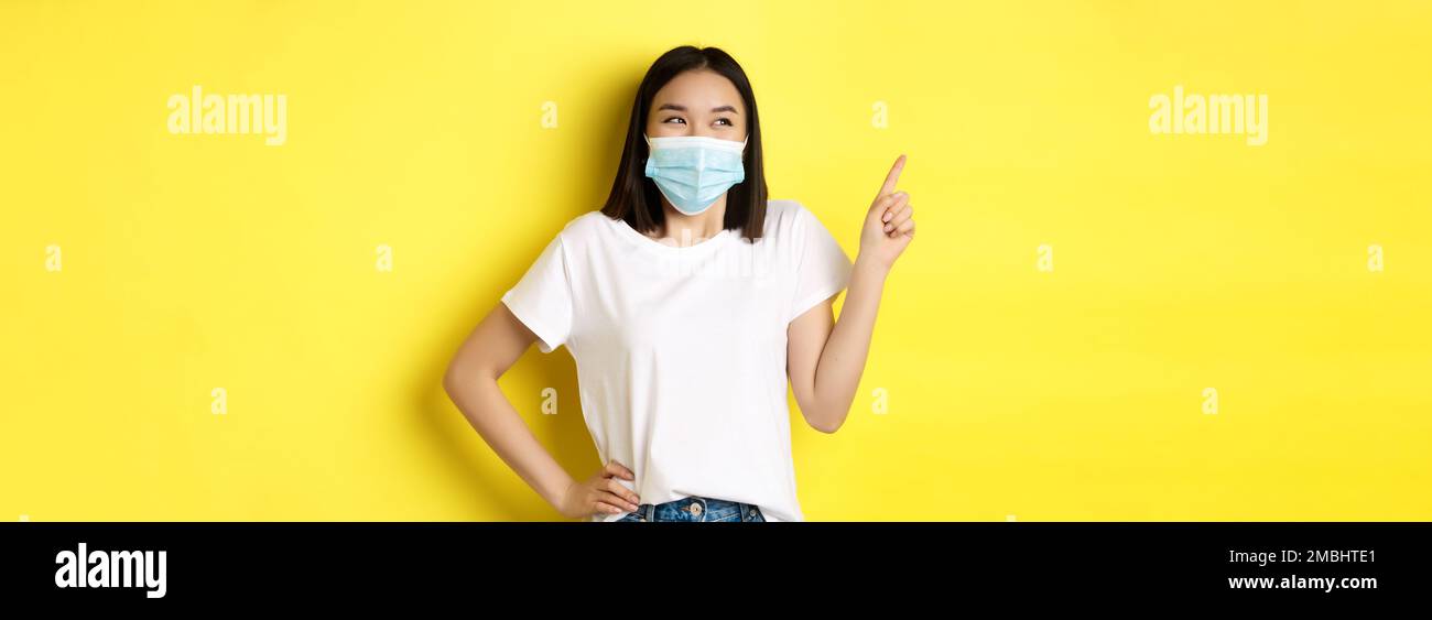 Covid, health care and pandemic concept. Asian woman in medical mask ...