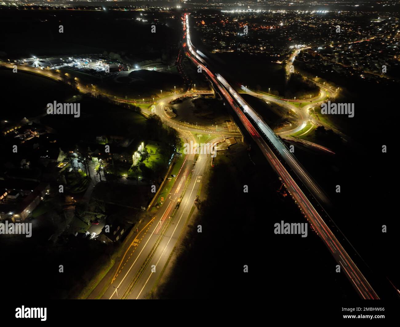 An aerial shot of urban Roundabout roads at night with yellow lighting Stock Photo - Alamy