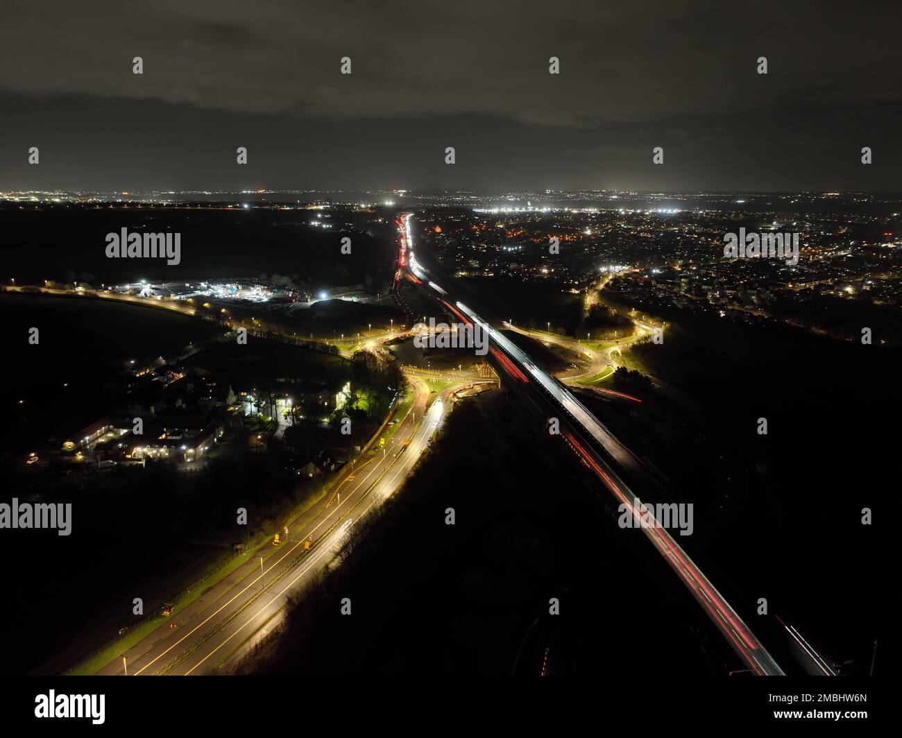 An aerial shot of urban Roundabout roads at night with yellow lighting ...