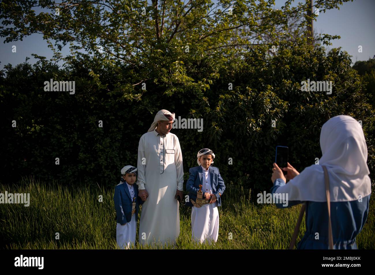 People take pictures after attending Eid al-Fitr prayers in Bucharest ...
