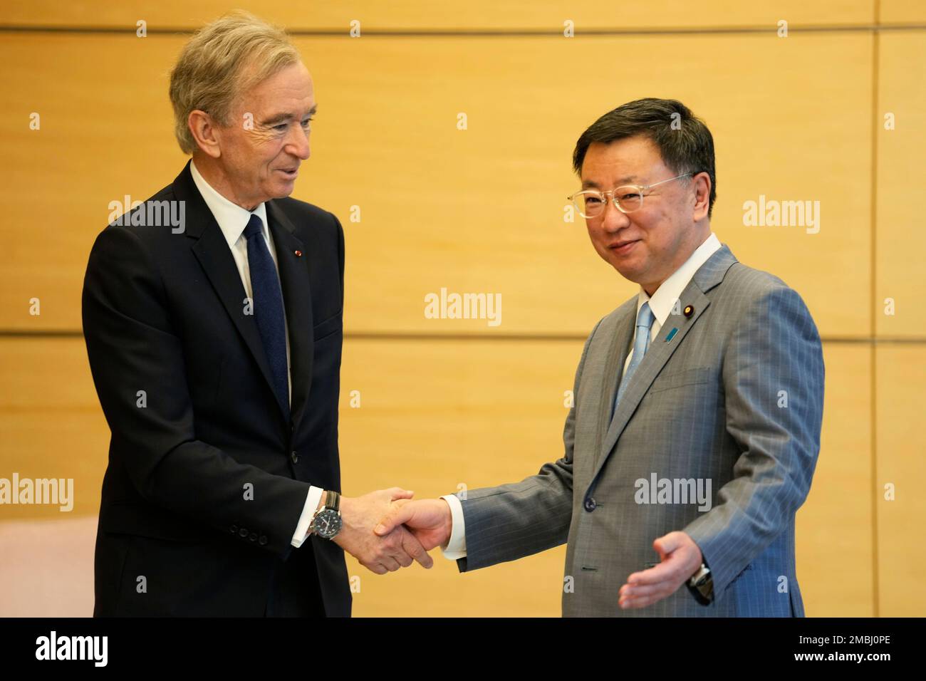 LVMH CEO Bernard Arnault, left, and Japanese Chief Cabinet Secretary ...