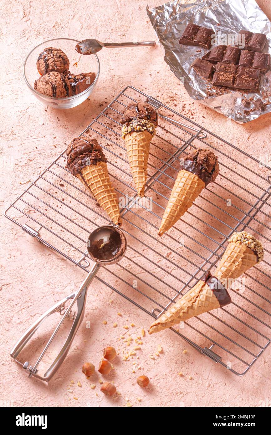 Chocolate ice cream on a metal rack with scoop from stainless steel ...