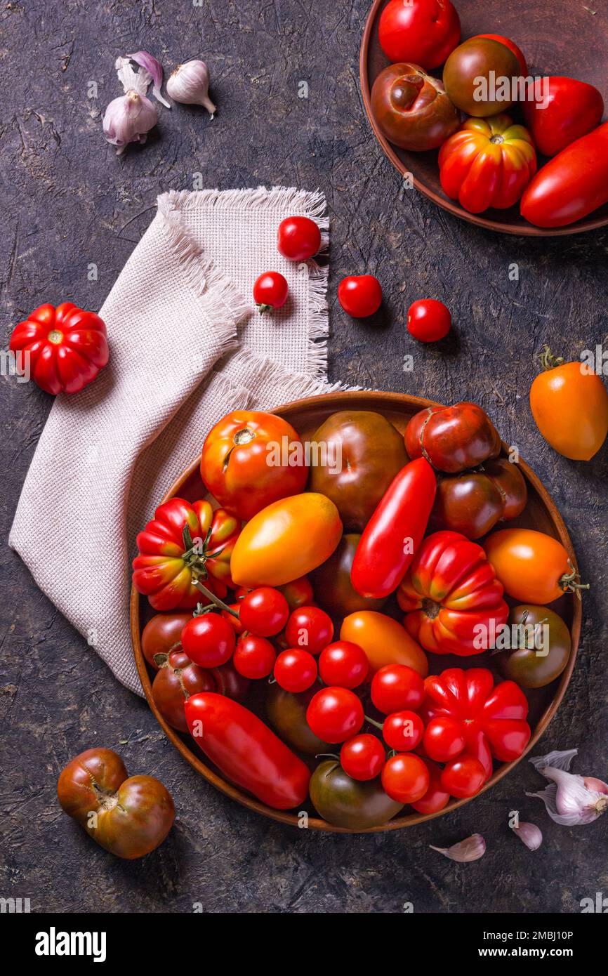 The harvest of assorted tomatoes. Colorful organic tomatoes on a large ...
