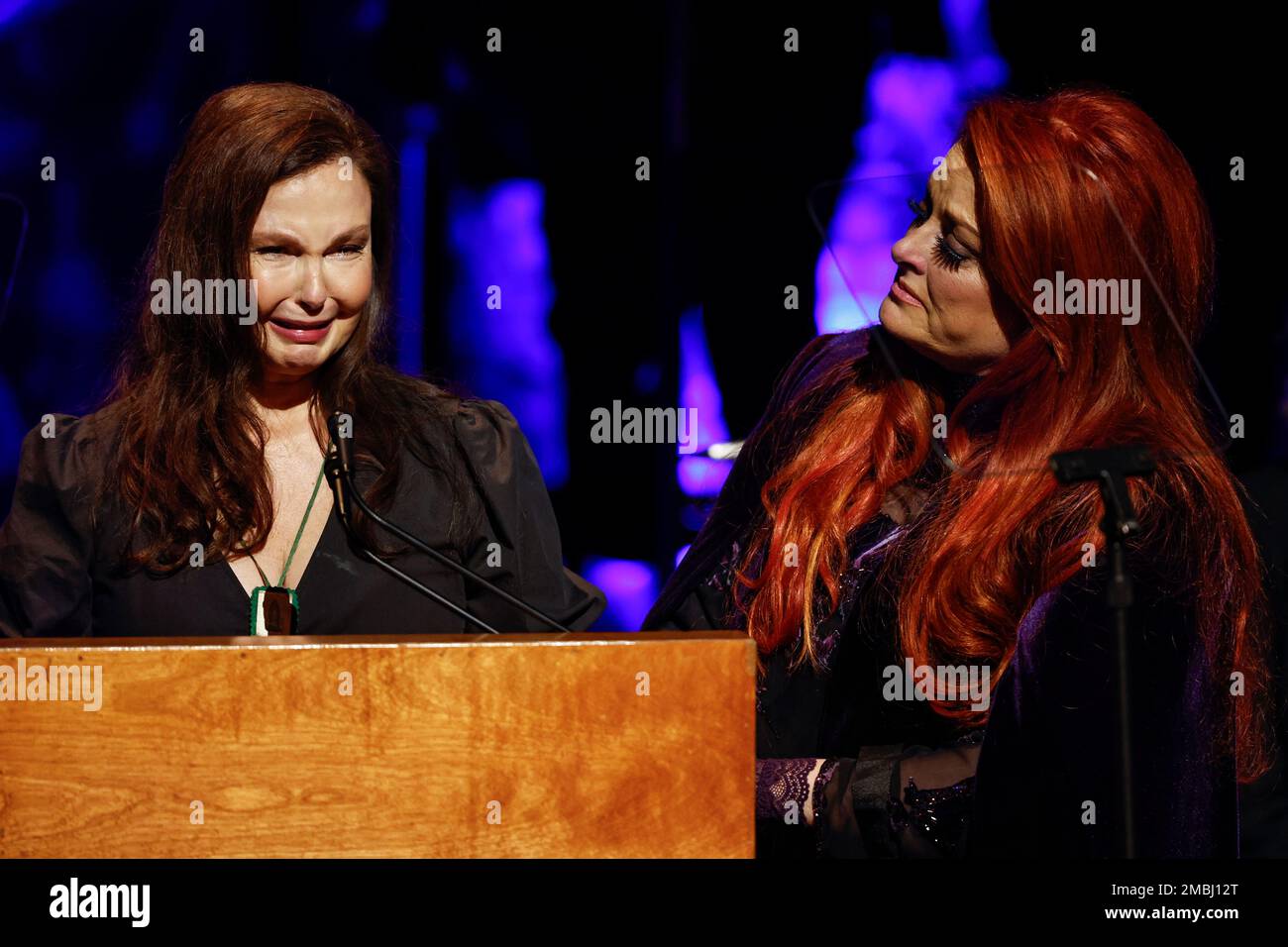 Ashley Judd, left, cries as she speaks as sister Wynonna Judd watches ...