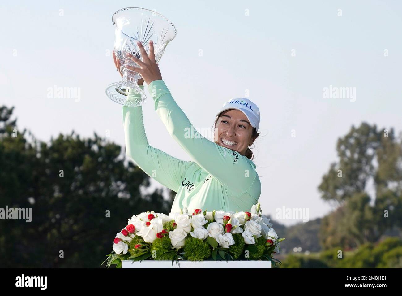 Marina Alex holds the championship trophy after winning the LPGA's ...