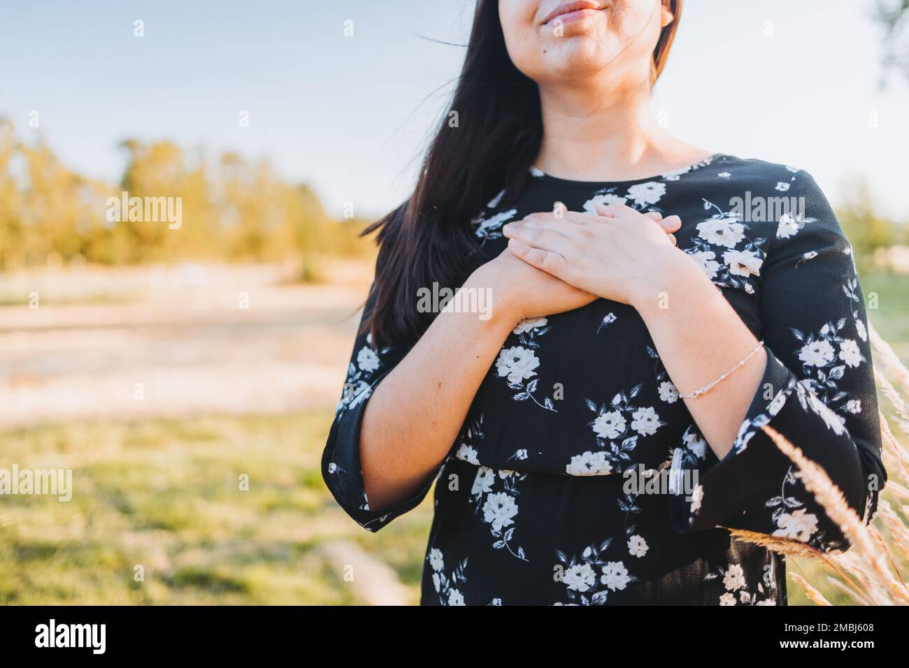 Unrecognizable Woman Putting Hands On Her Heart In Gratitude For Gods