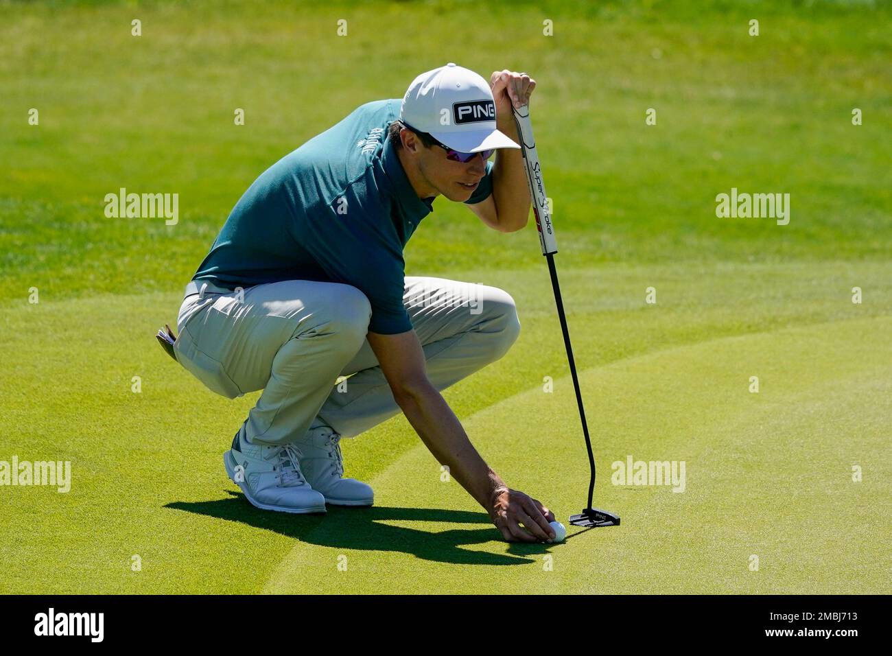 Abraham Ancer, of Mexico, lines up a putt on the first hole during the ...