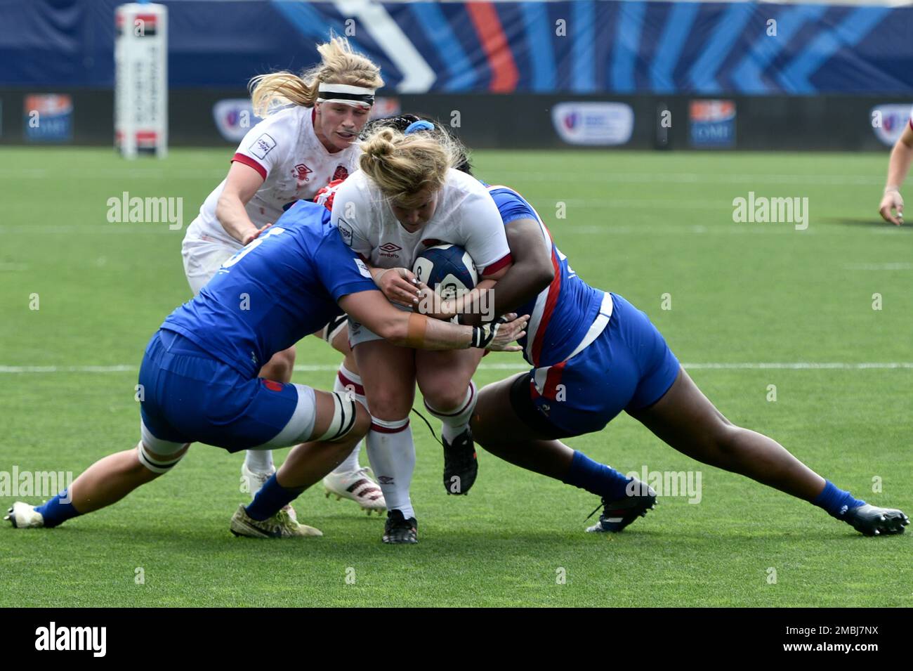 England's Lark Davies, center, is tackled by France's Audrey Forlani ...