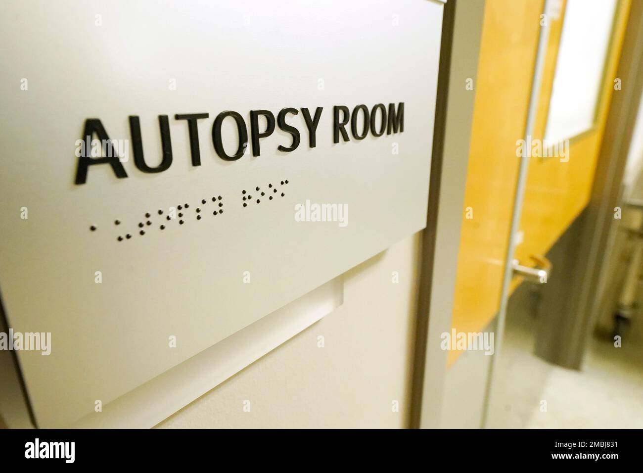 The four-bay autopsy room is pictured across from the morgue cooler at ...