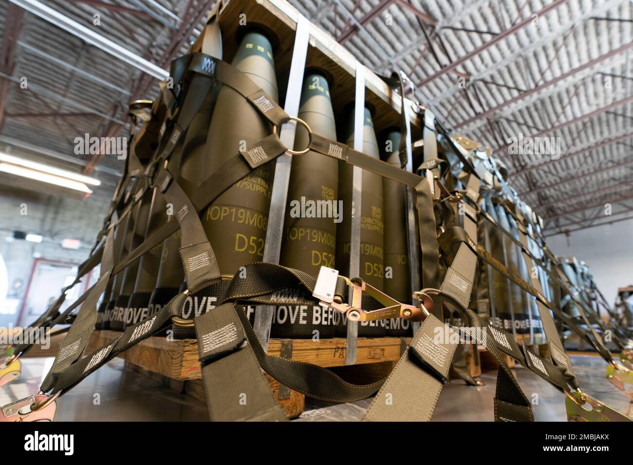 Pallets of 155 mm shells ultimately bound for Ukraine are loaded by the ...