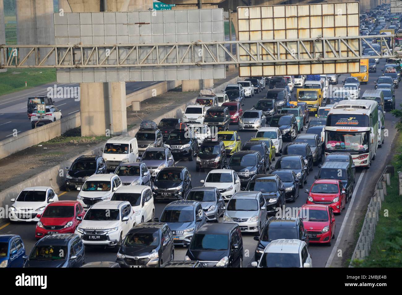 Vehicles are caught in a congestion as the flow of traffic increases at toll road in Cikarang ...