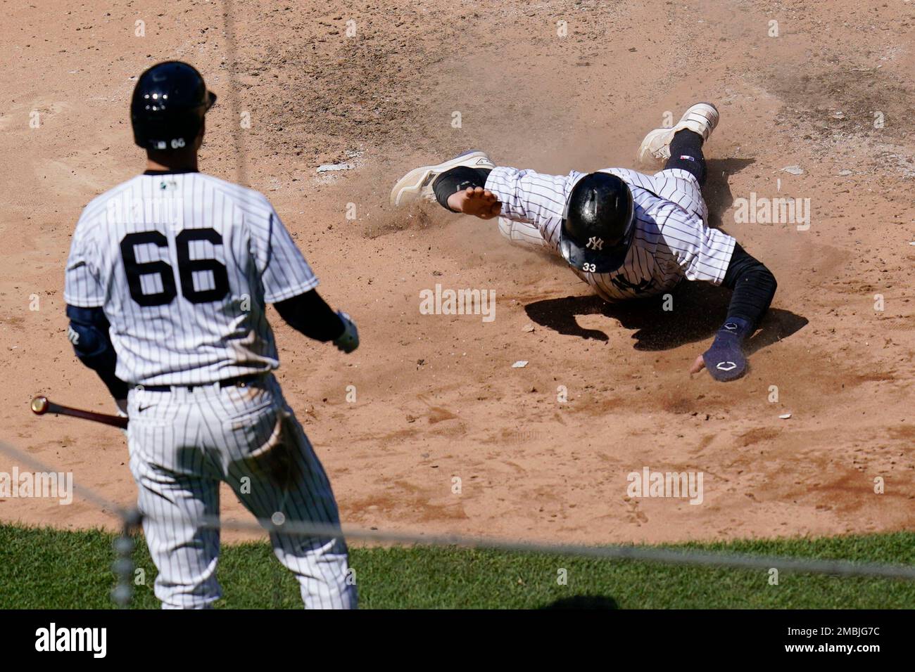 New York Yankees' Tim Locastro, right, celebrates crossing home plate ...