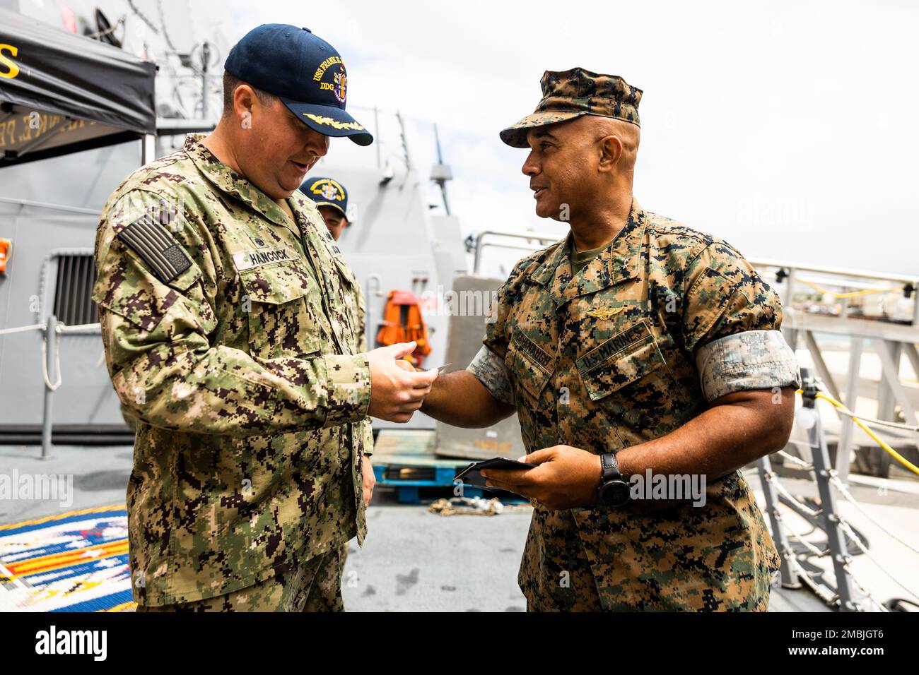 U.S. Navy Cmdr. Daniel Hancock, left, commanding officer, USS Frank E ...