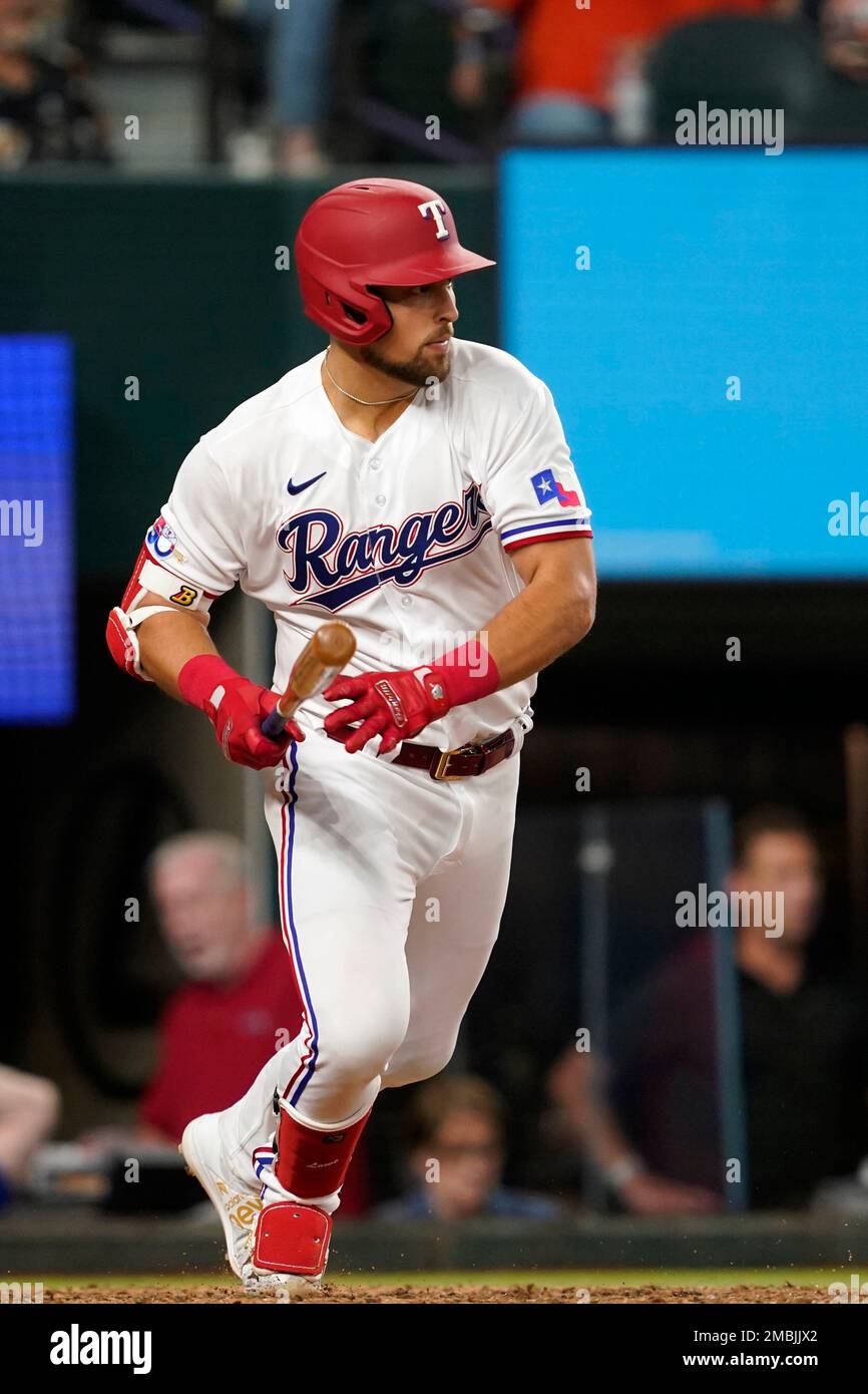 Texas Rangers' Nathaniel Lowe follows through on a swing during a ...