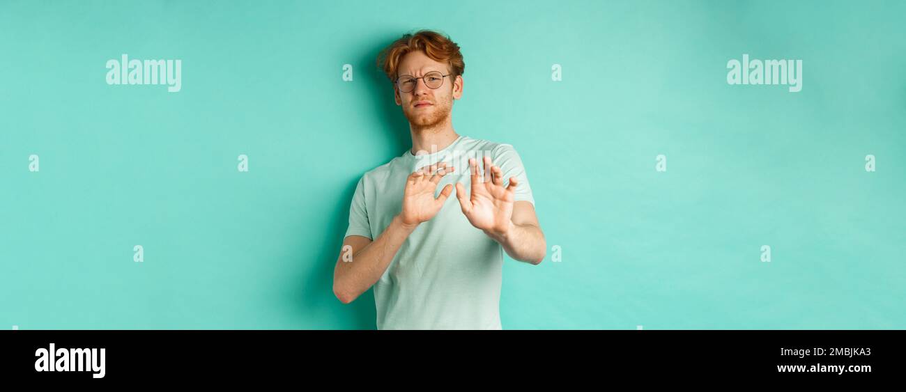 Reluctant Redhead Man In Glasses Raising Hands In Refusal Gesture Step