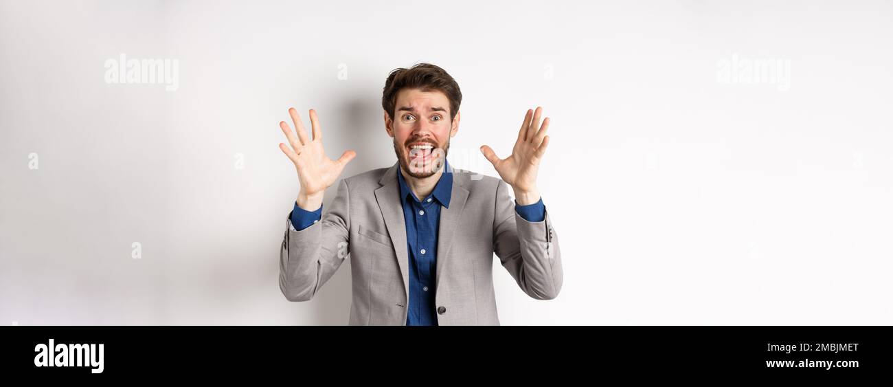 Businessman scream and shake hands in panic, look alarmed and anxious ...