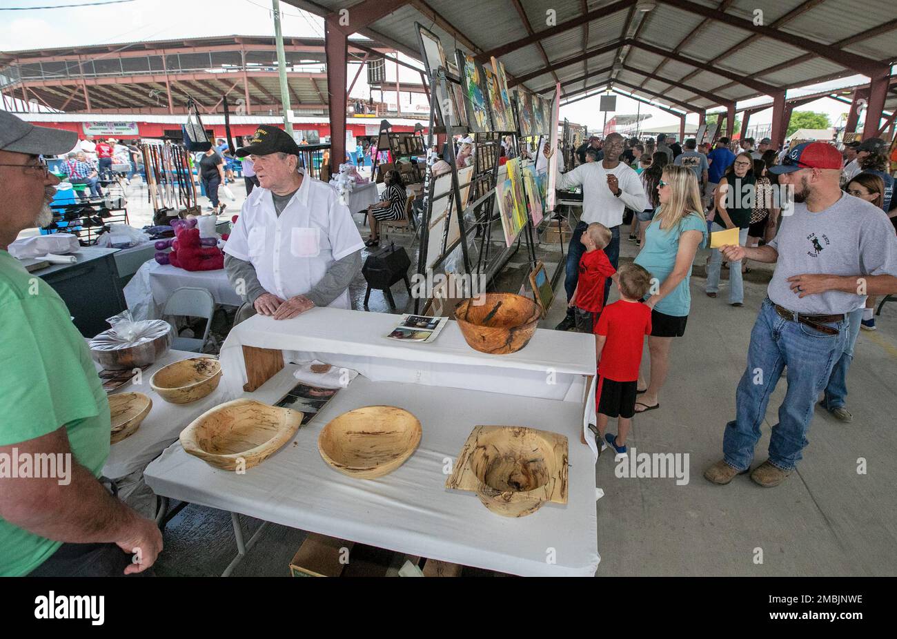 77-year-old inmate Jimmie Graves (left in white shirt) makes a sale of ...
