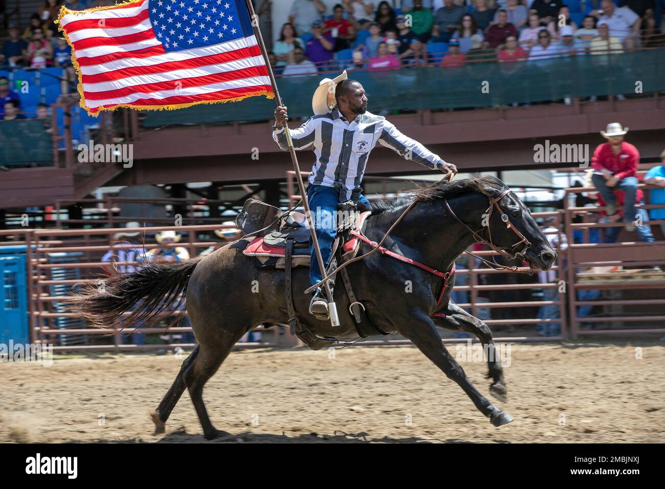 An inmate displays his great horsemanship and the US flag during the ...