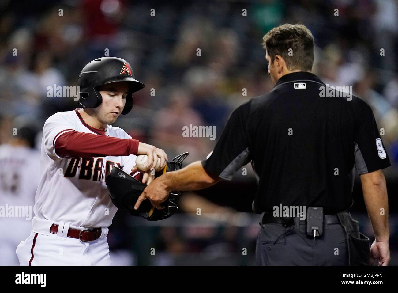 Umpire Ben May gets a delivery of new baseballs from the Arizona ...