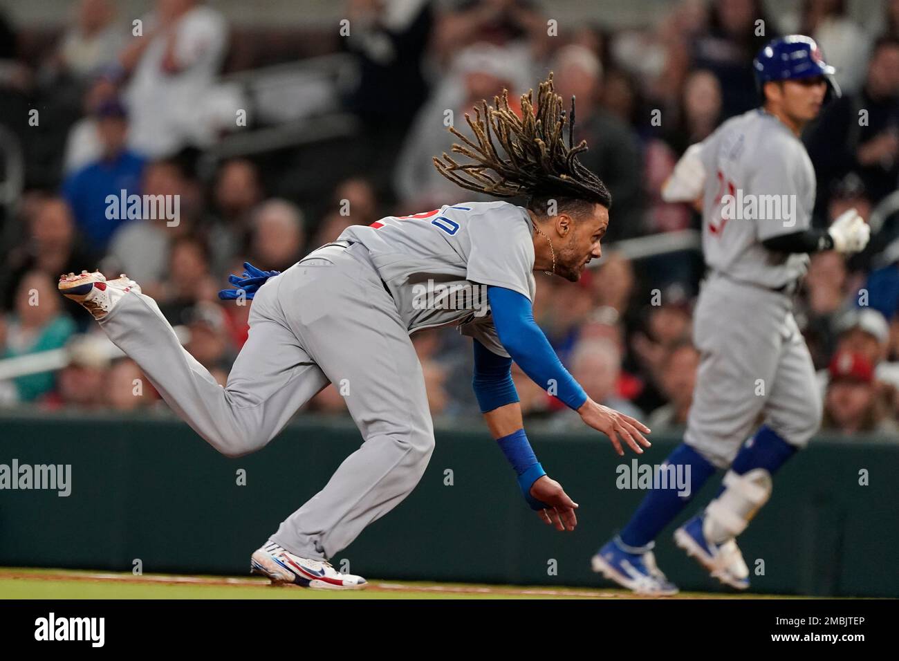 Chicago Cubs' Michael Hermosillo (32) dives into first base before ...