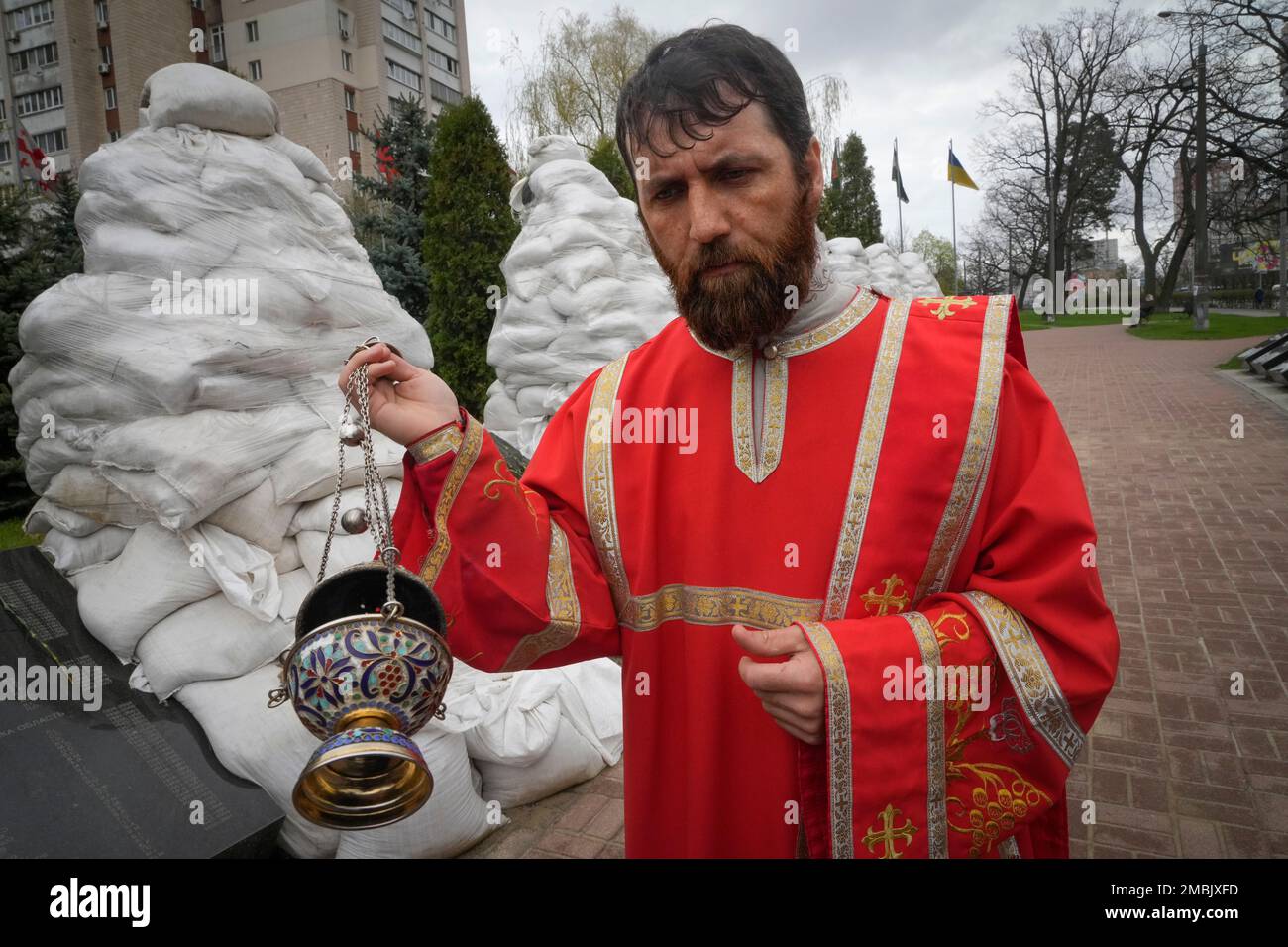 An Orthodox priest holds a commemorative ceremony to pay respect to the ...