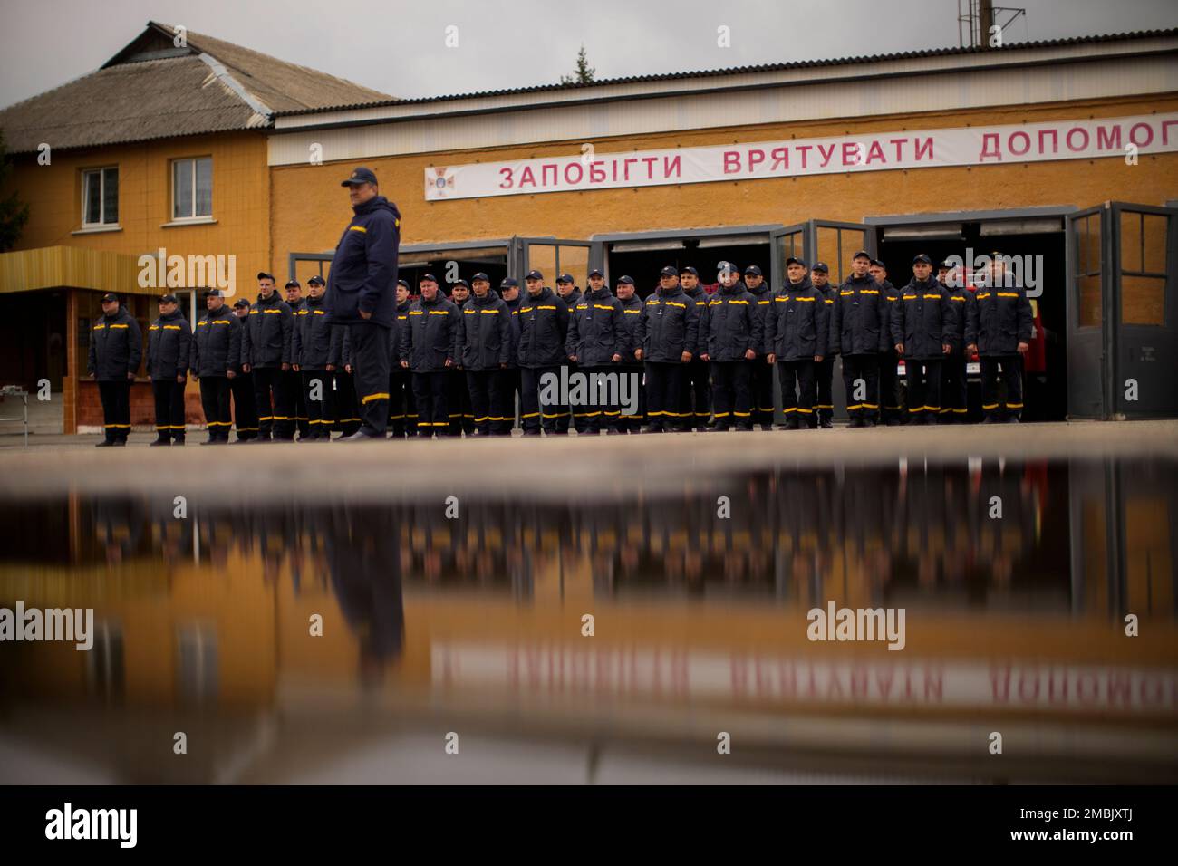 Members of the 11th State Fire and Rescue Unit stand during a ceremony ...