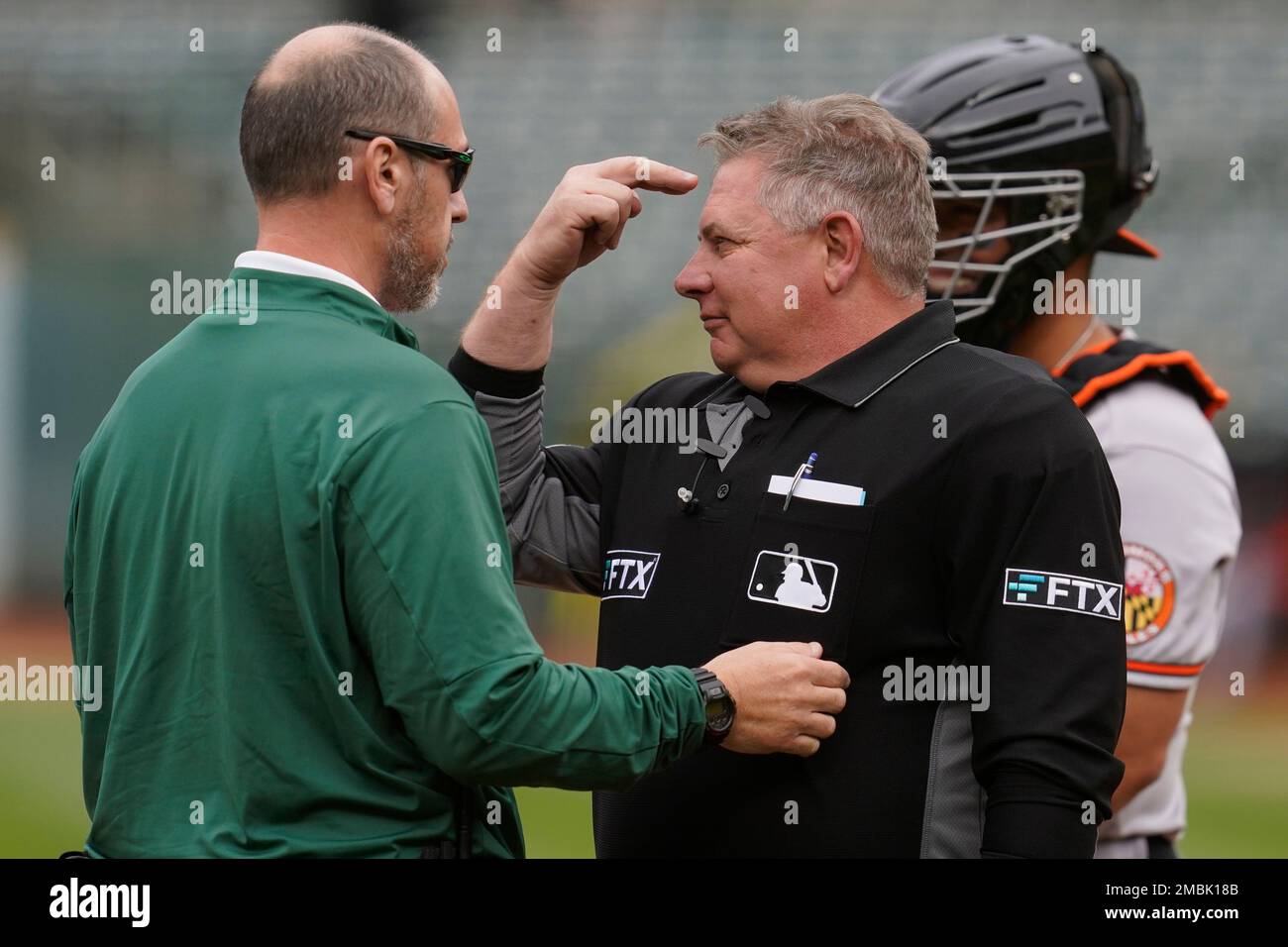 Umpire Greg Gibson is checked on during a baseball game between the ...