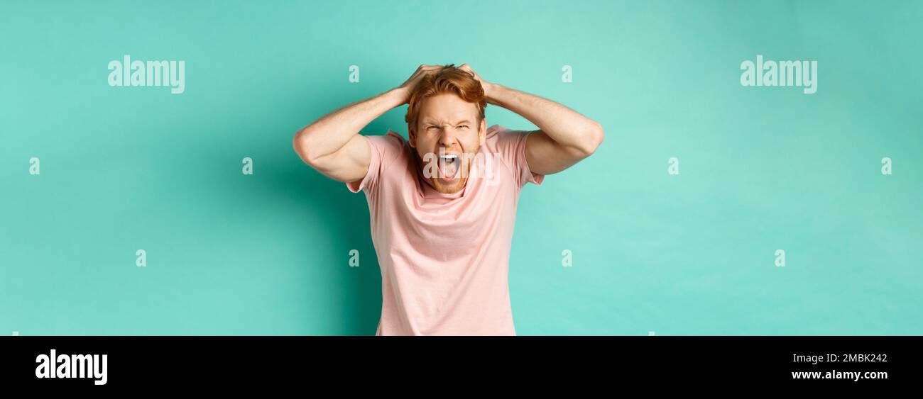 Angry redhead man screaming and ripping hair out of head, yelling and ...