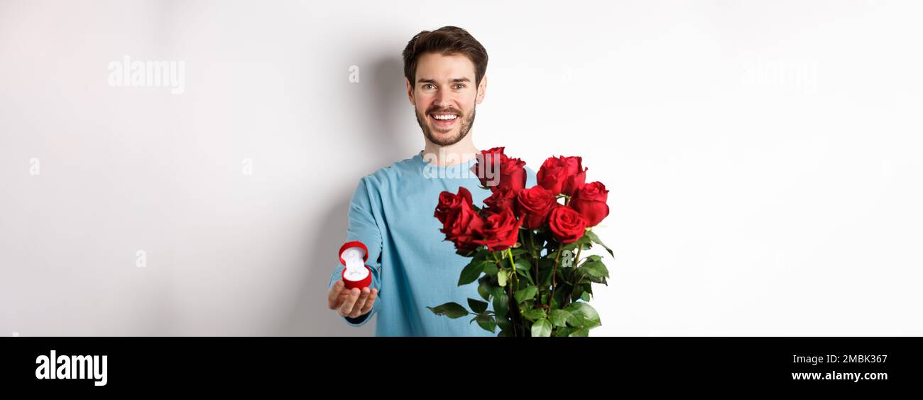 Handsome young man boyfriend making a proposal on Valentines lovers day ...