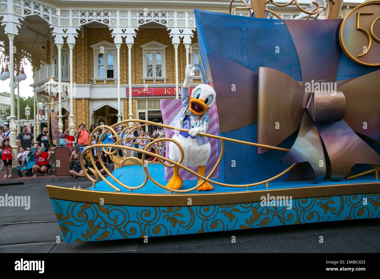 A performer dressed as Donald Duck entertains visitors from a float at ...