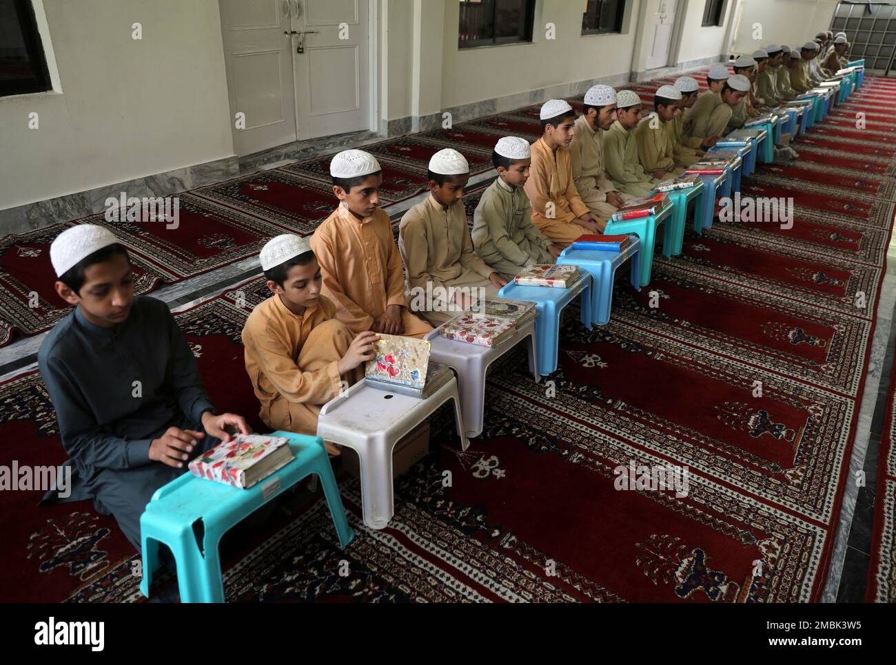 Pakistani boys read from the Quran during the Muslim holy month of ...