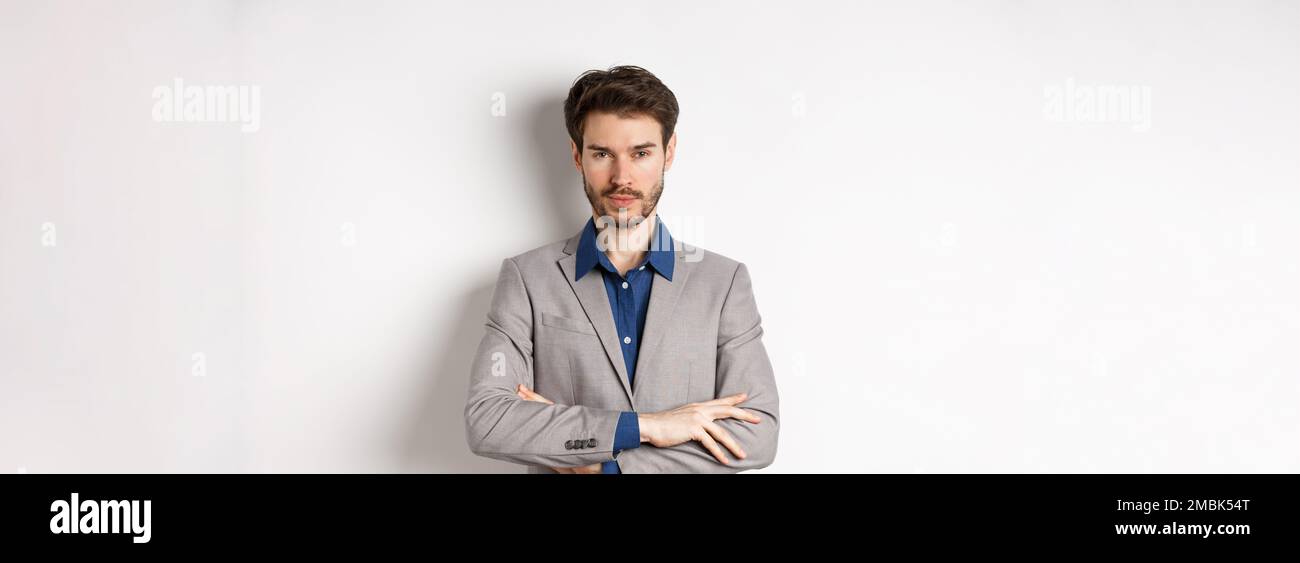 Confident young man looking like professional, cross arms on chest in ...