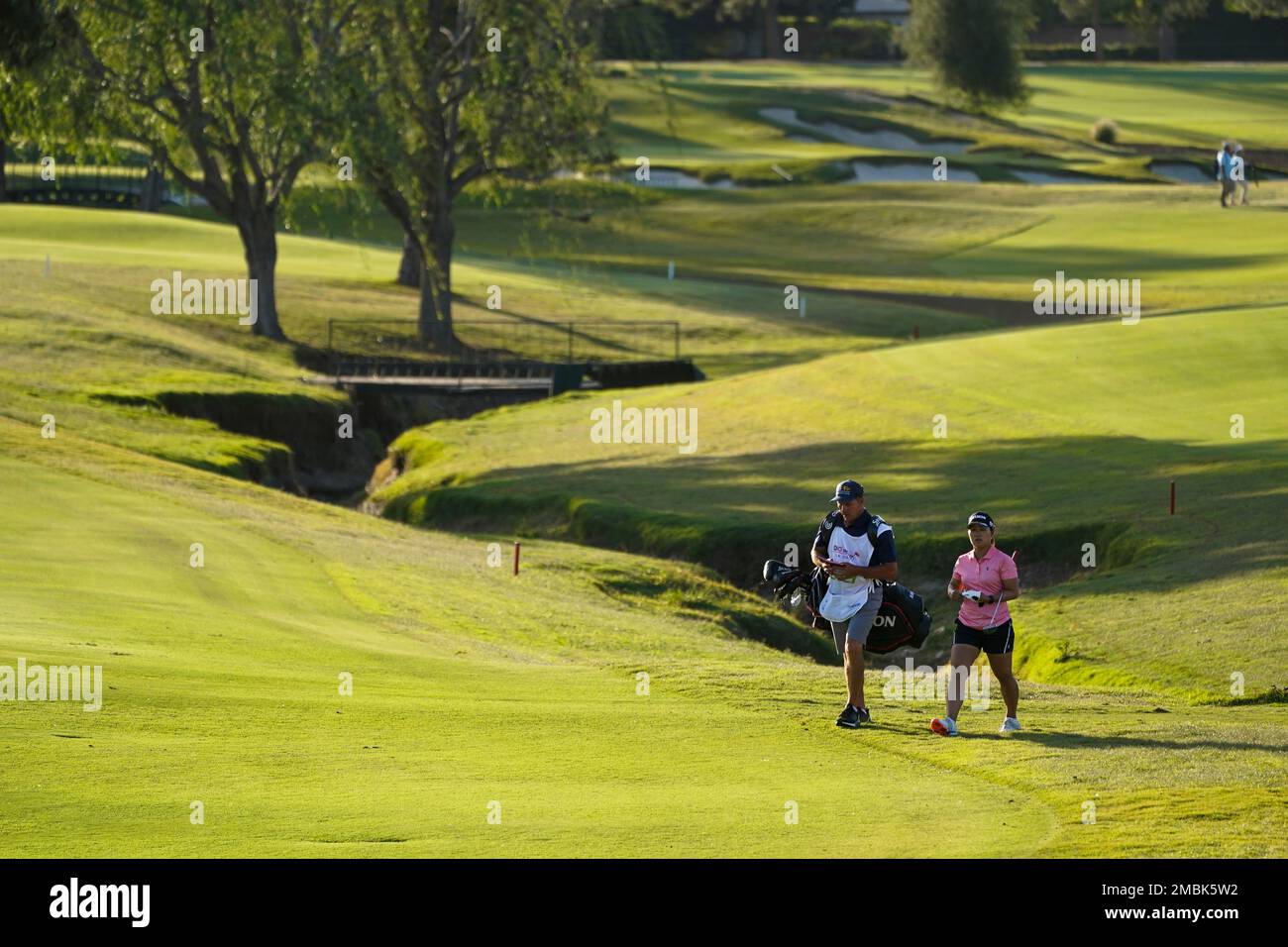Nasa Hataoka and her caddie walk on the 17th fairway during the final ...
