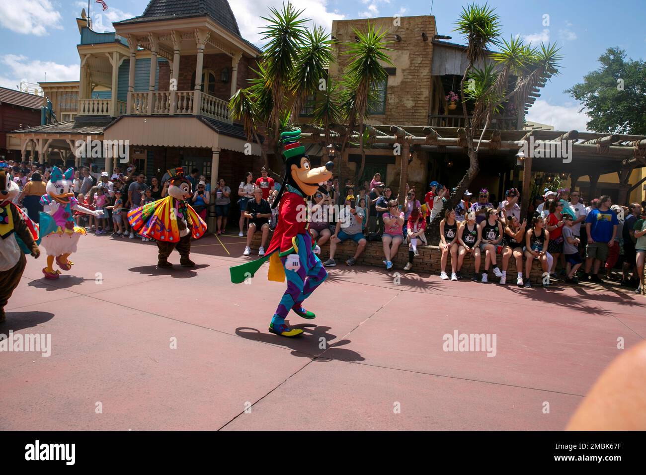 A performer dressed as Goofy entertains parade-goers at Magic Kingdom ...