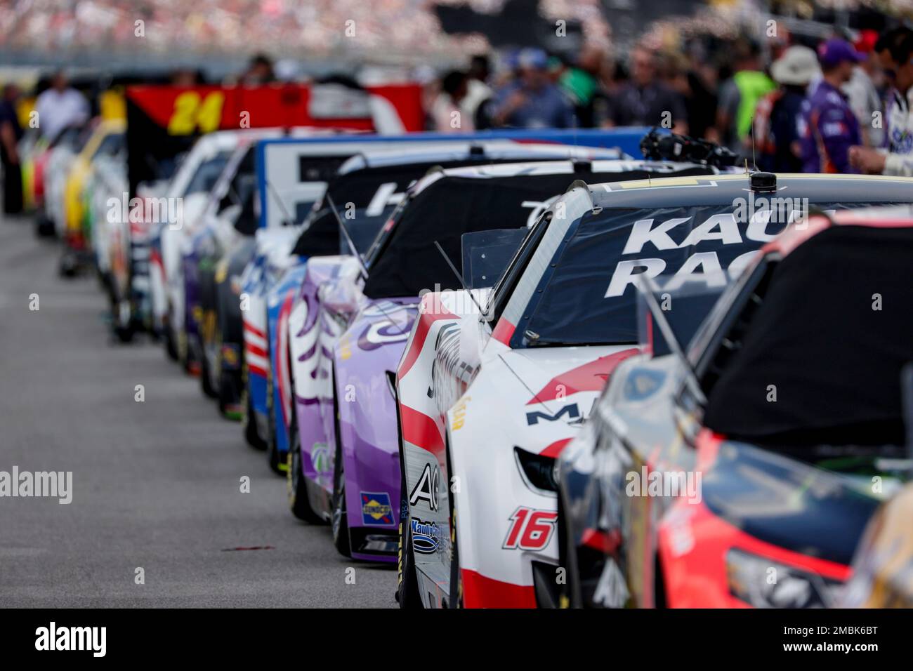 Cars sit along pit road before the NASCAR Cup Series auto race, Sunday ...
