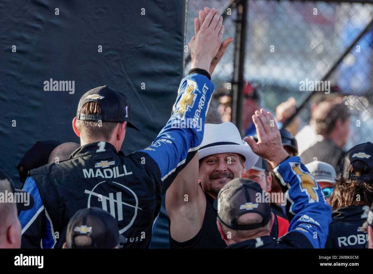 Singer Kid Rock (center) celebrates with the crew of NASCAR Cup Series ...