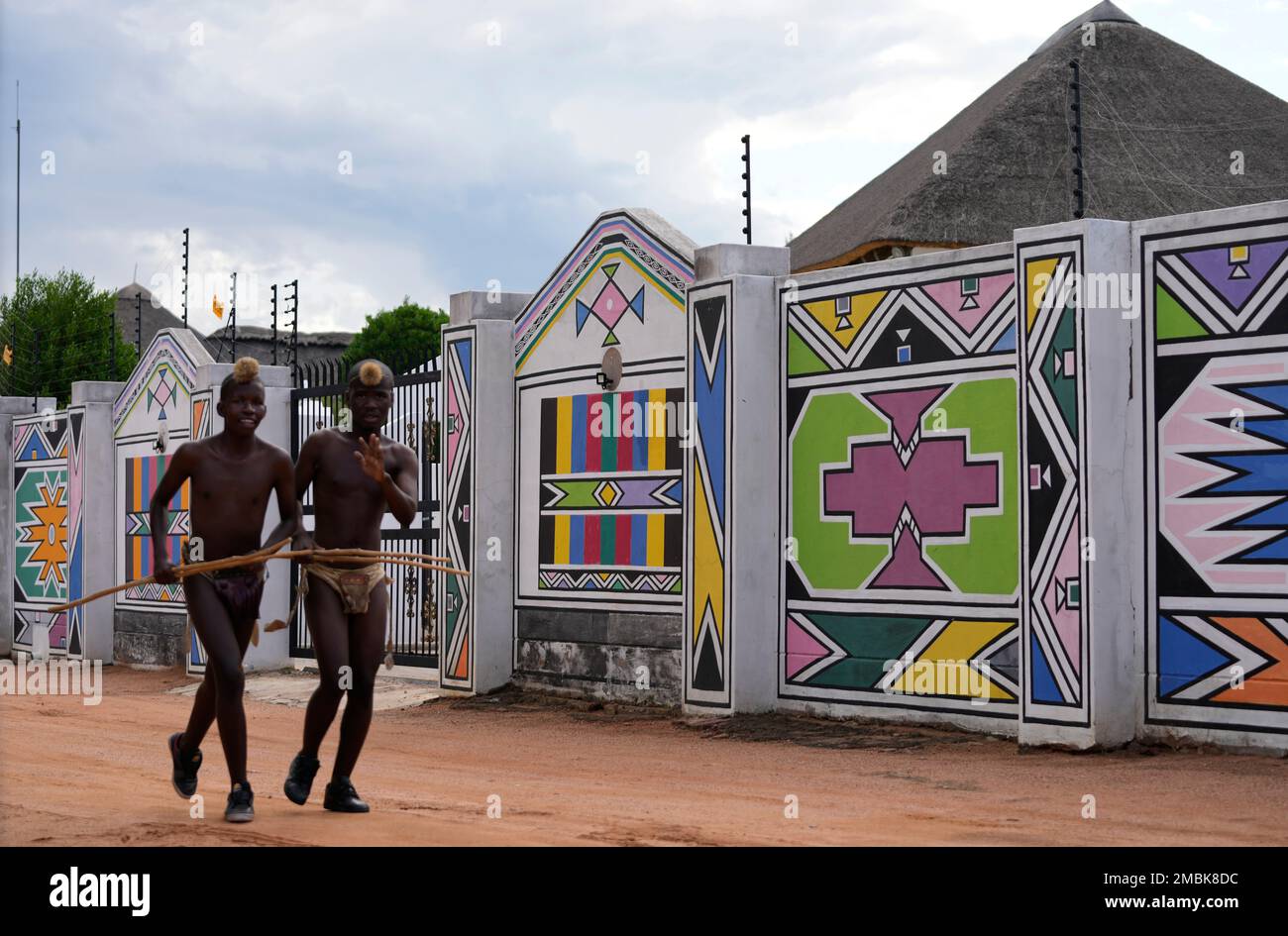 Ndebele initiates run past the house of Esther Mahlangu, a contemporary ...