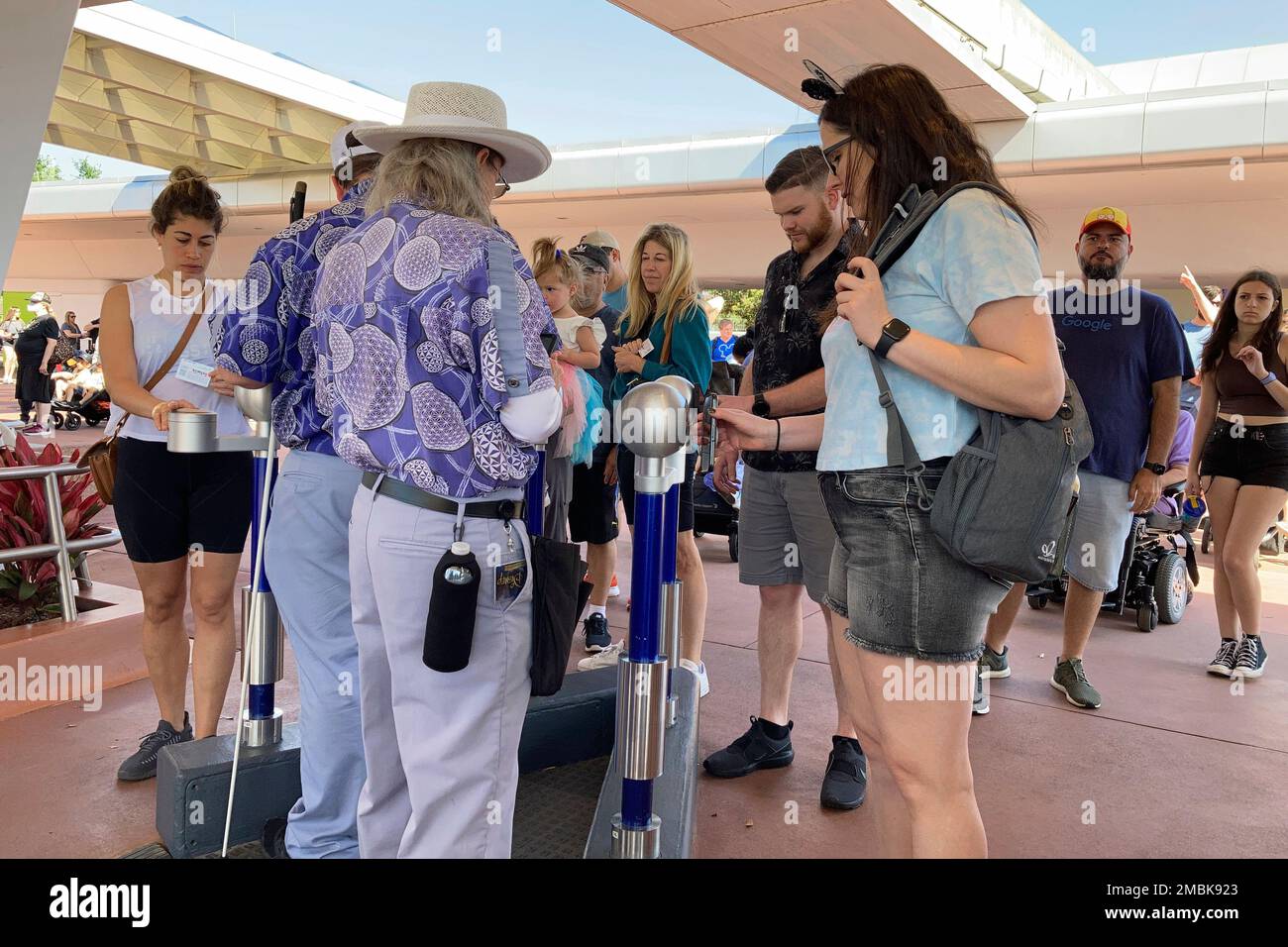 Visitors use electronic tickets on their phones to enter Epcot theme ...