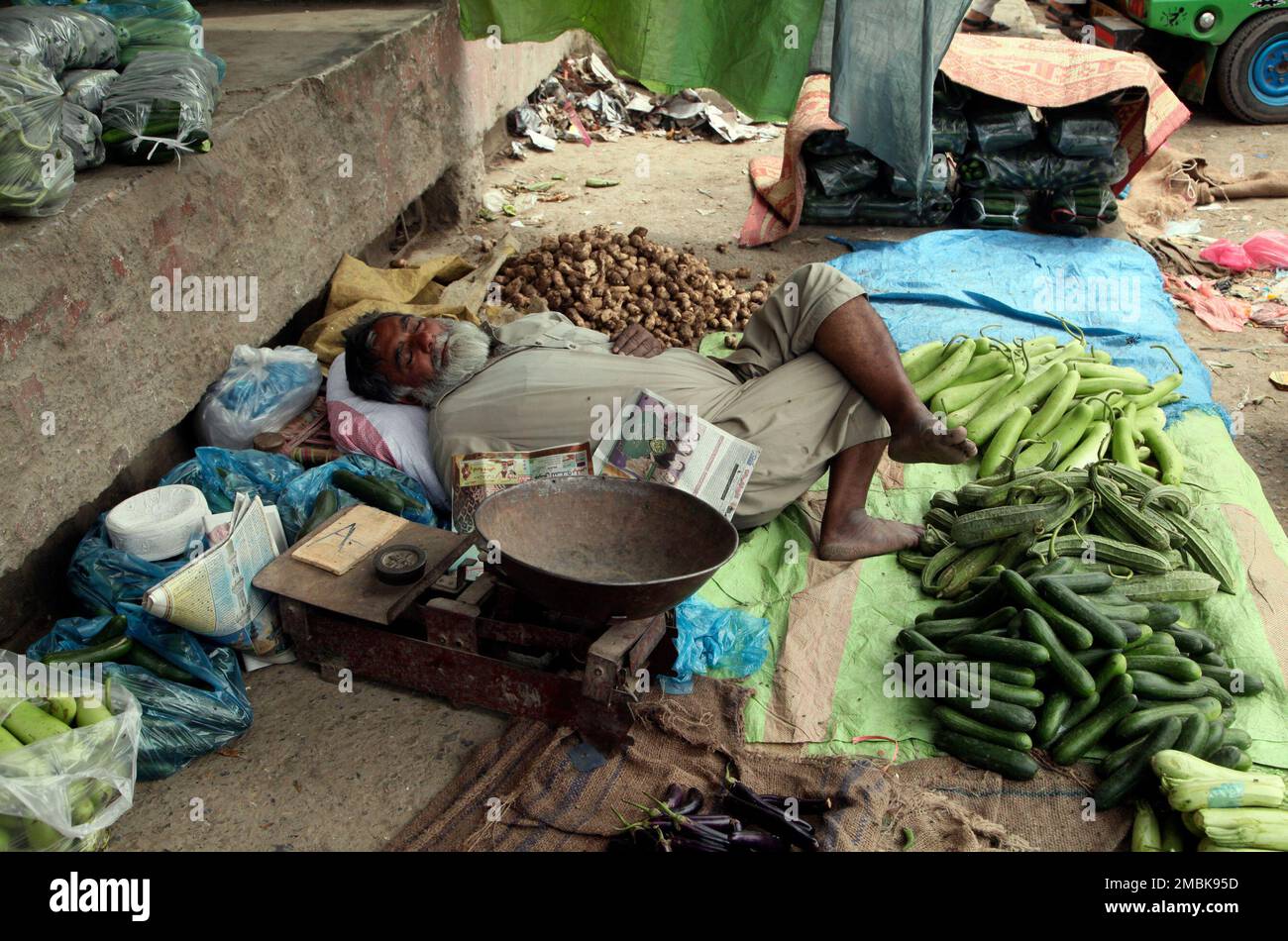 A vegetable seller rests in his stall during the Muslim holy fasting ...
