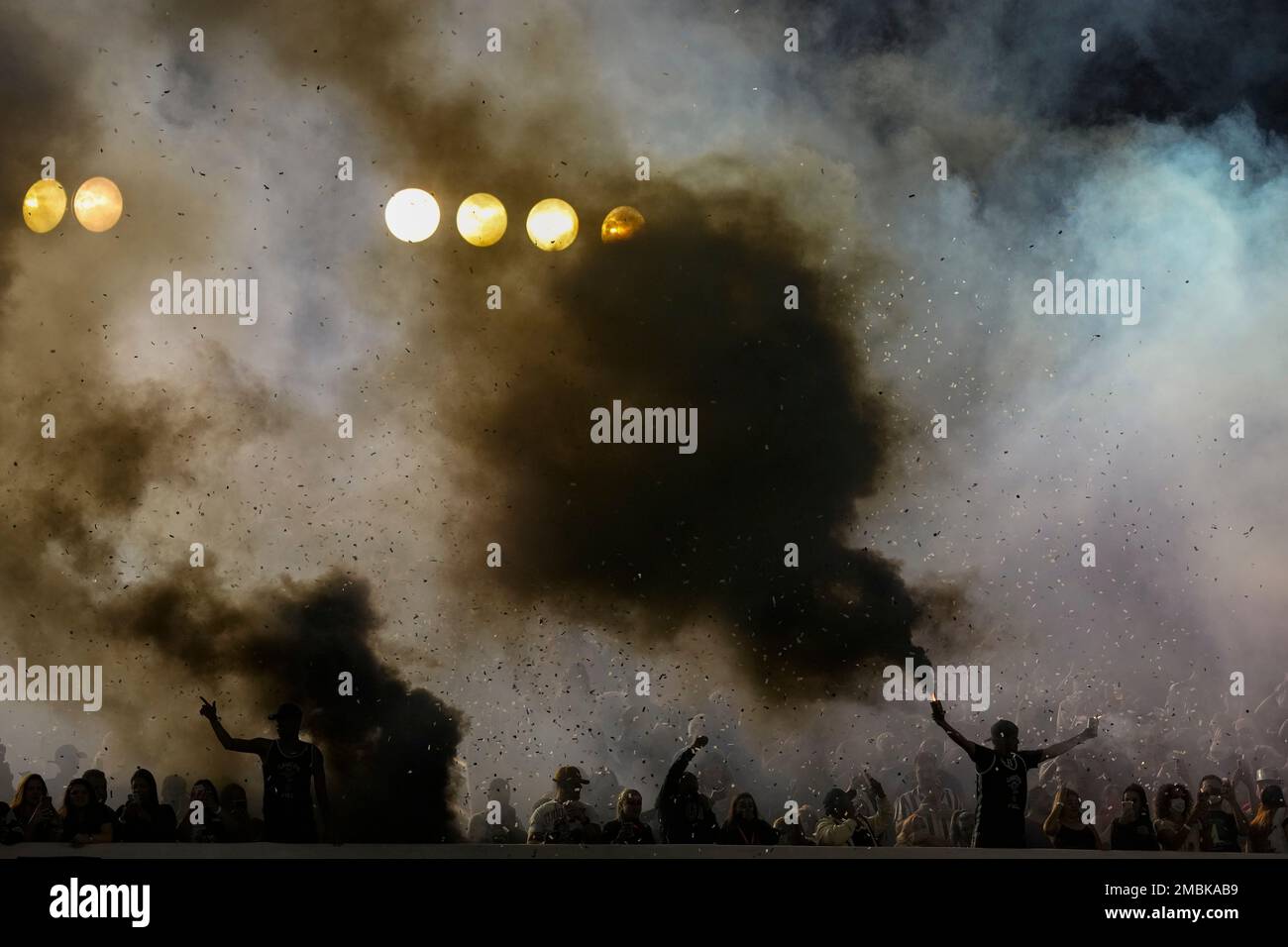 Fans cheer and light flares in the stands during the Gavioes da Fiel ...