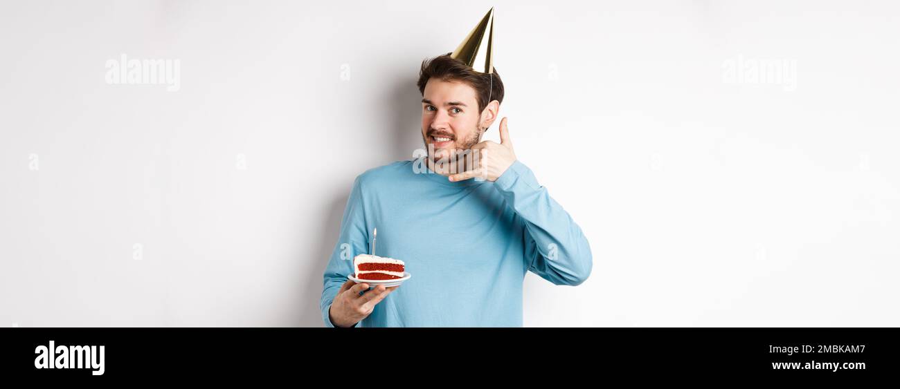 Celebration and holidays concept. Cheerful smiling man in party hat ...