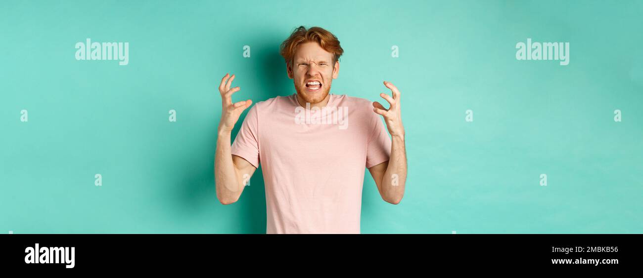 Annoyed and pissed-off redhead guy looking angry, shouting and ...