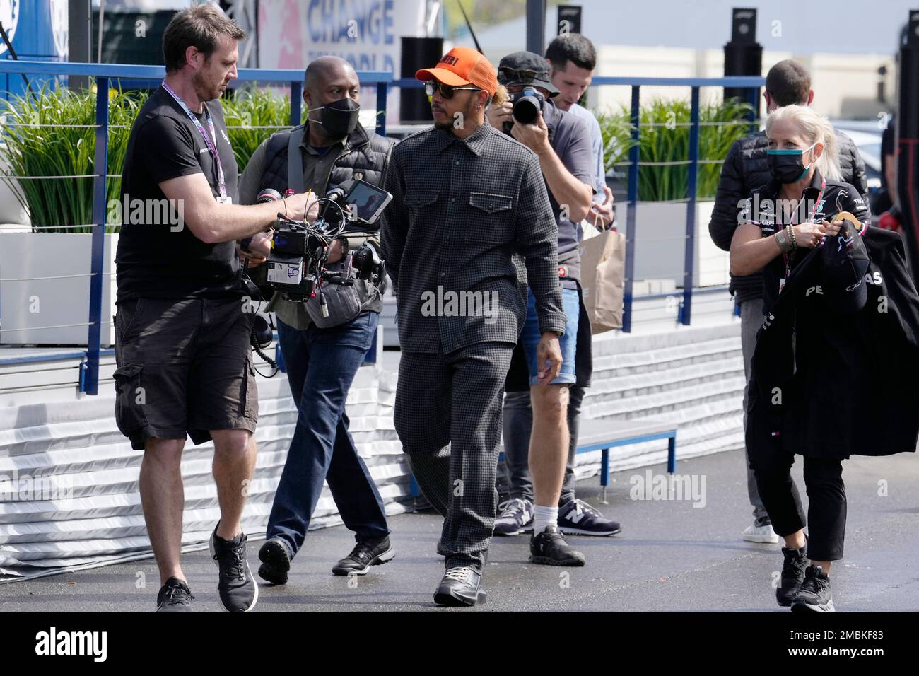 Mercedes driver Lewis Hamilton of Britain arrives in the paddock at the ...