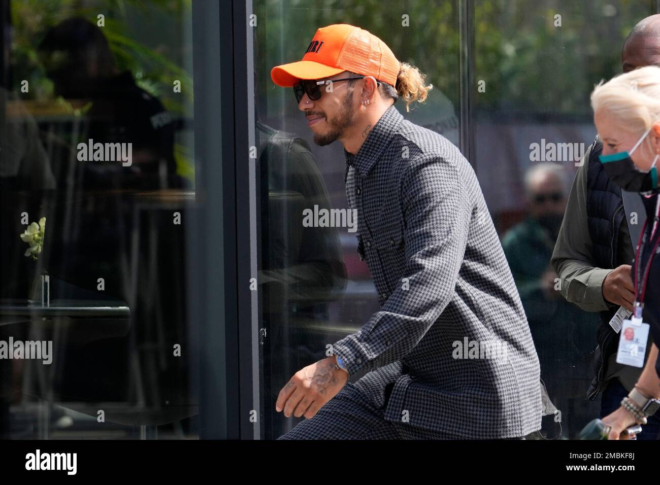 Mercedes driver Lewis Hamilton of Britain arrives in the paddock at the ...
