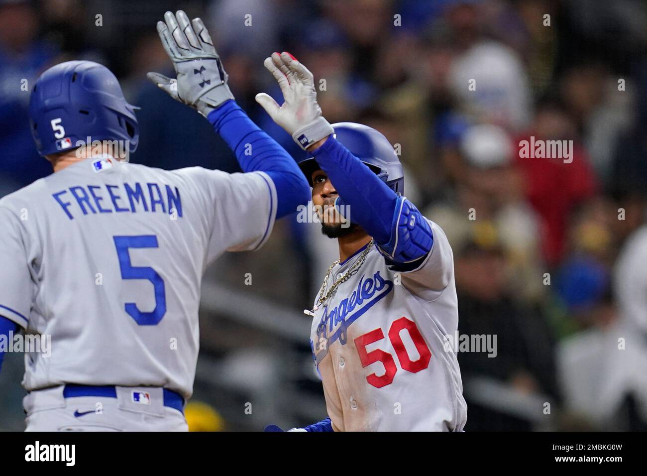 Los Angeles Dodgers' Mookie Betts (50) is greeted by Freddie Freeman ...