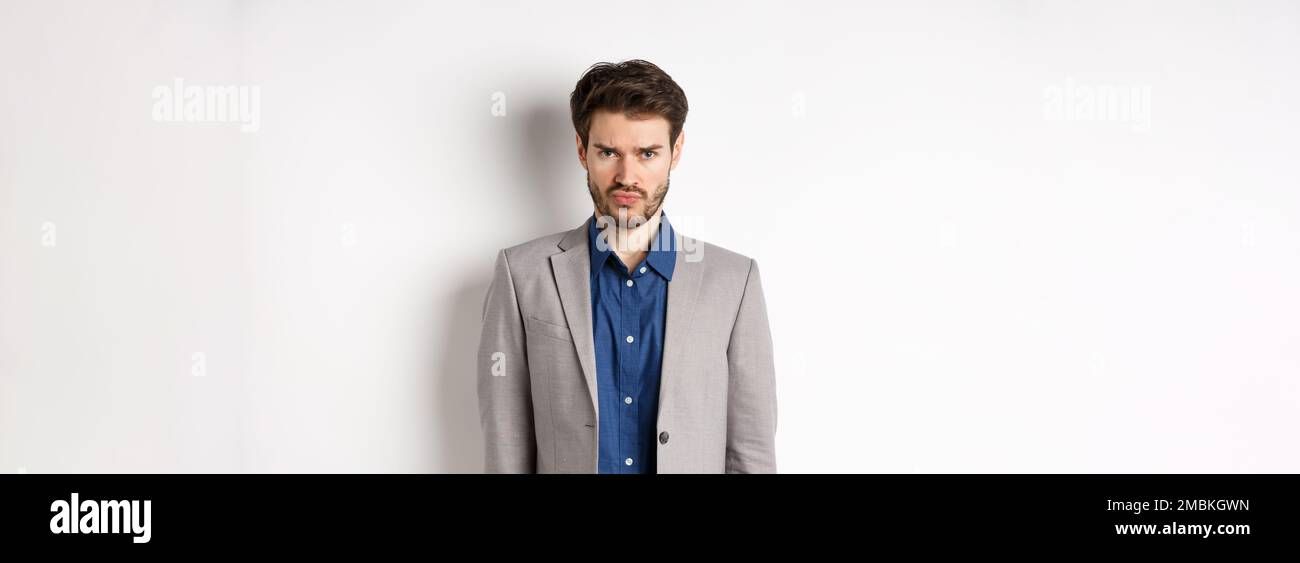 Sad offended guy sulking, wearing business suit, feel something unfair ...