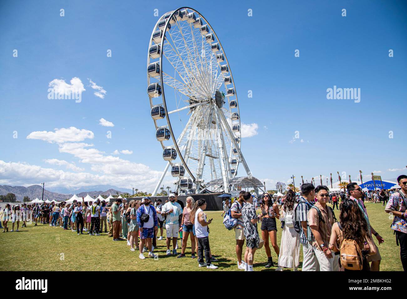 Festivalgoers stand in the merchandise line at the Coachella Music ...