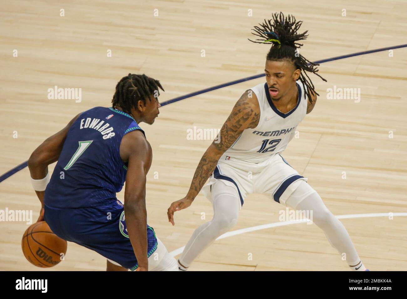 Minnesota Timberwolves forward Anthony Edwards (1) drives on Memphis Grizzlies guard Ja Morant ...