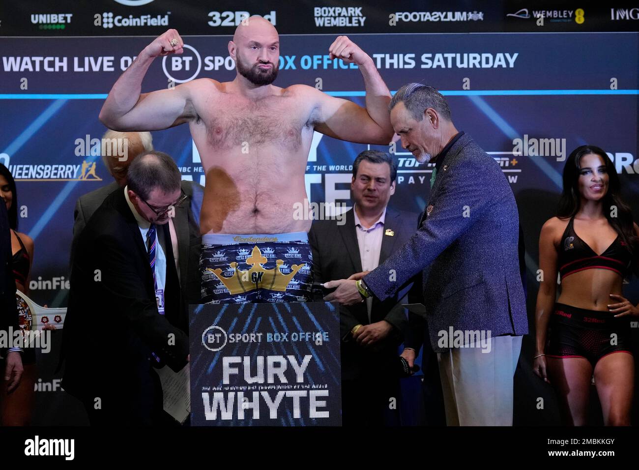 British heavyweight boxers Tyson Fury shows his muscles during weigh-in ...